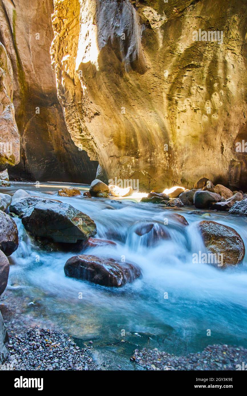 Golden yellow gorge with blue waterfalls over colorful red rocks Stock ...