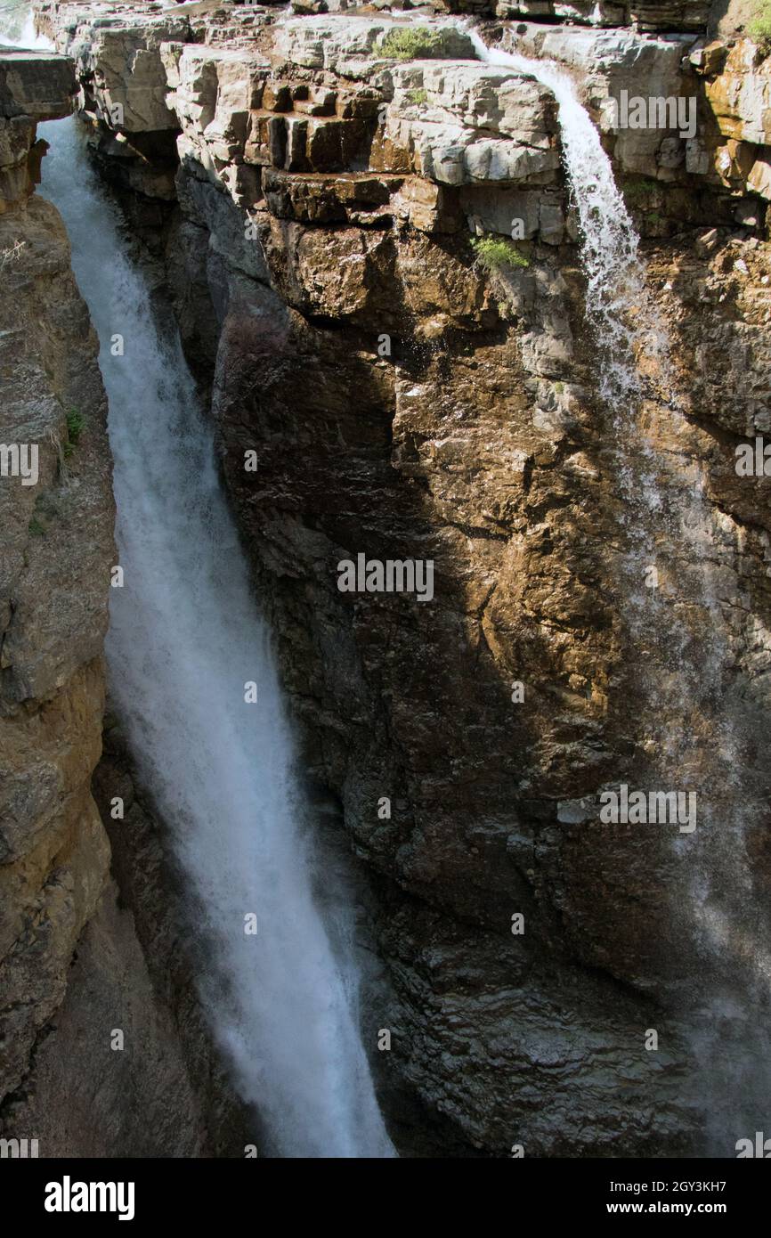 Two waterfalls flowing over a rock cliff face Stock Photo - Alamy
