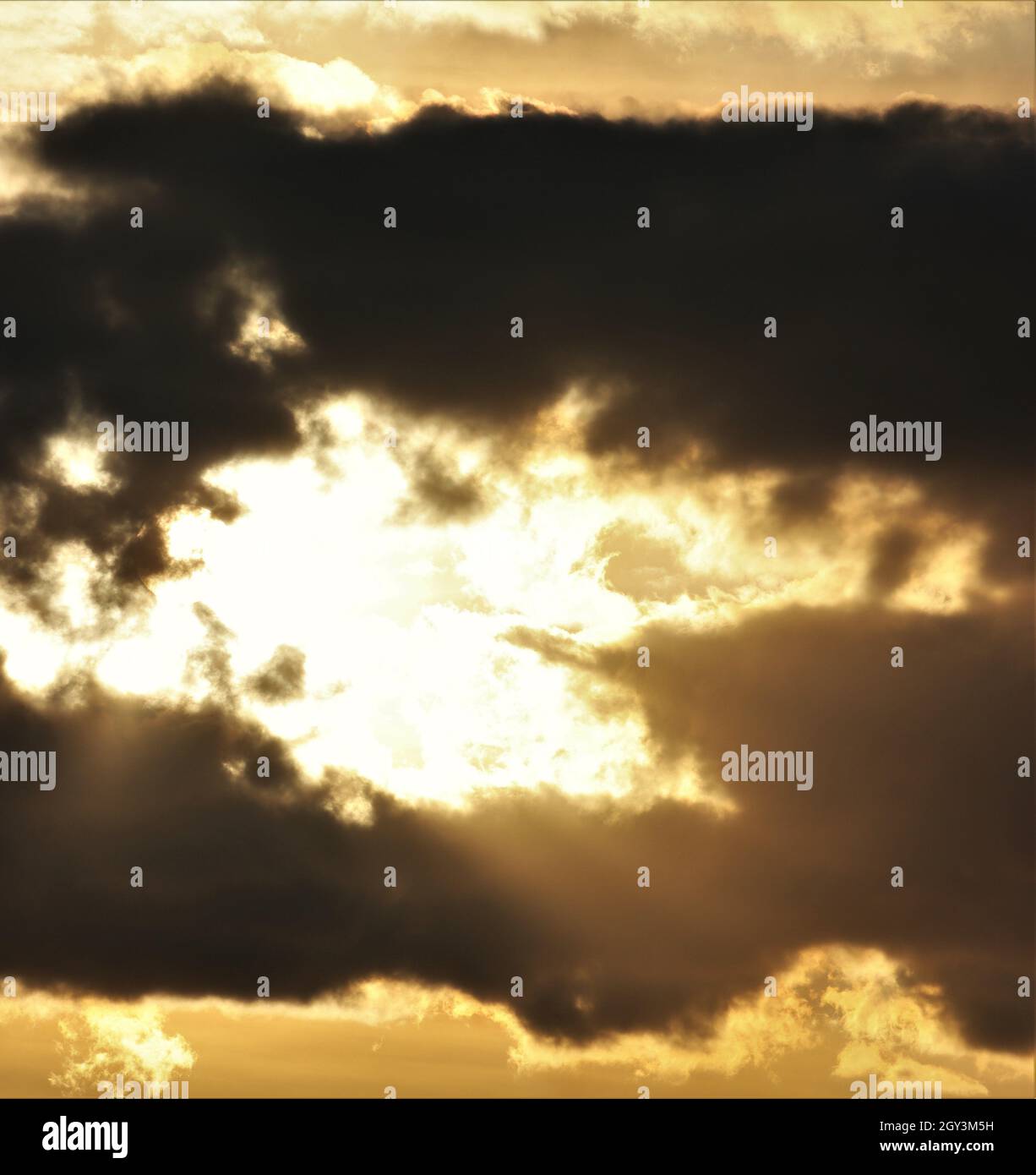 Low angle shot of dark clouds covering the sun Stock Photo - Alamy