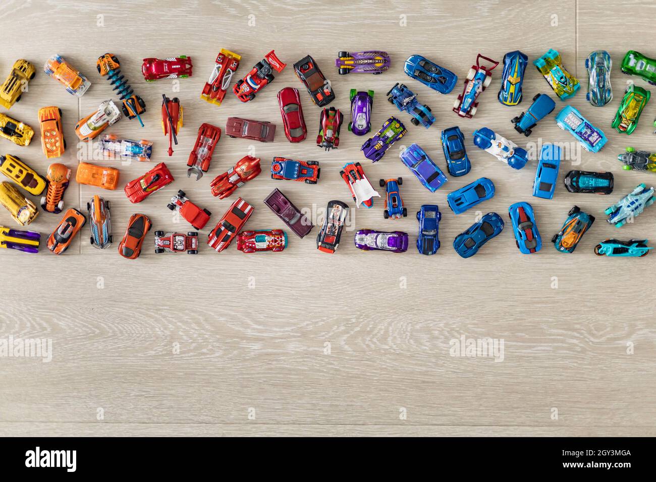 Top view random collection of model sport car toy hot wheels on wooden ...