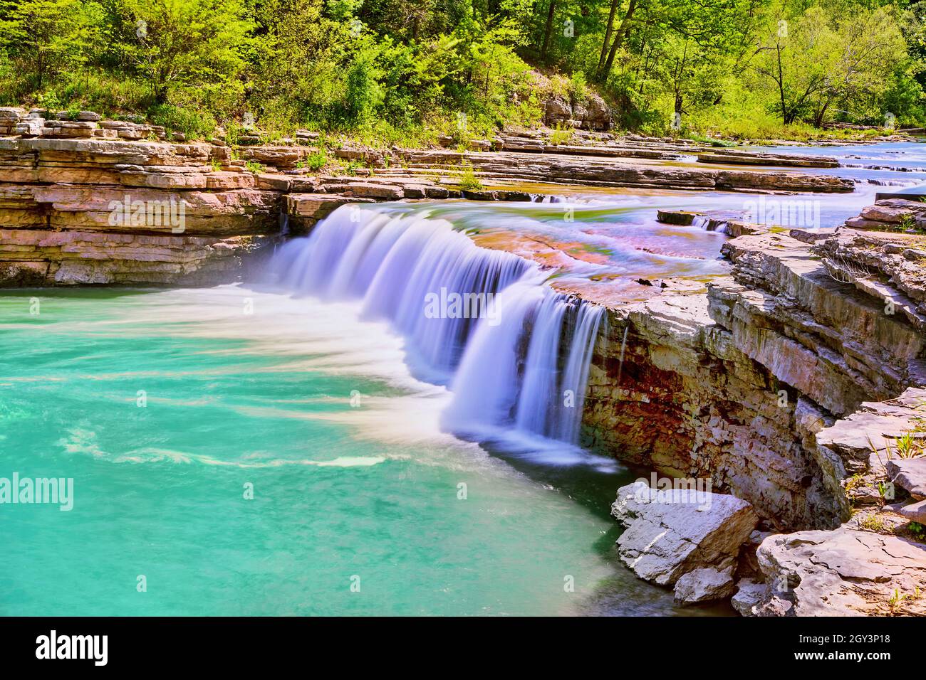 Vibrant blue waterfall in cliffs of gorge Stock Photo - Alamy