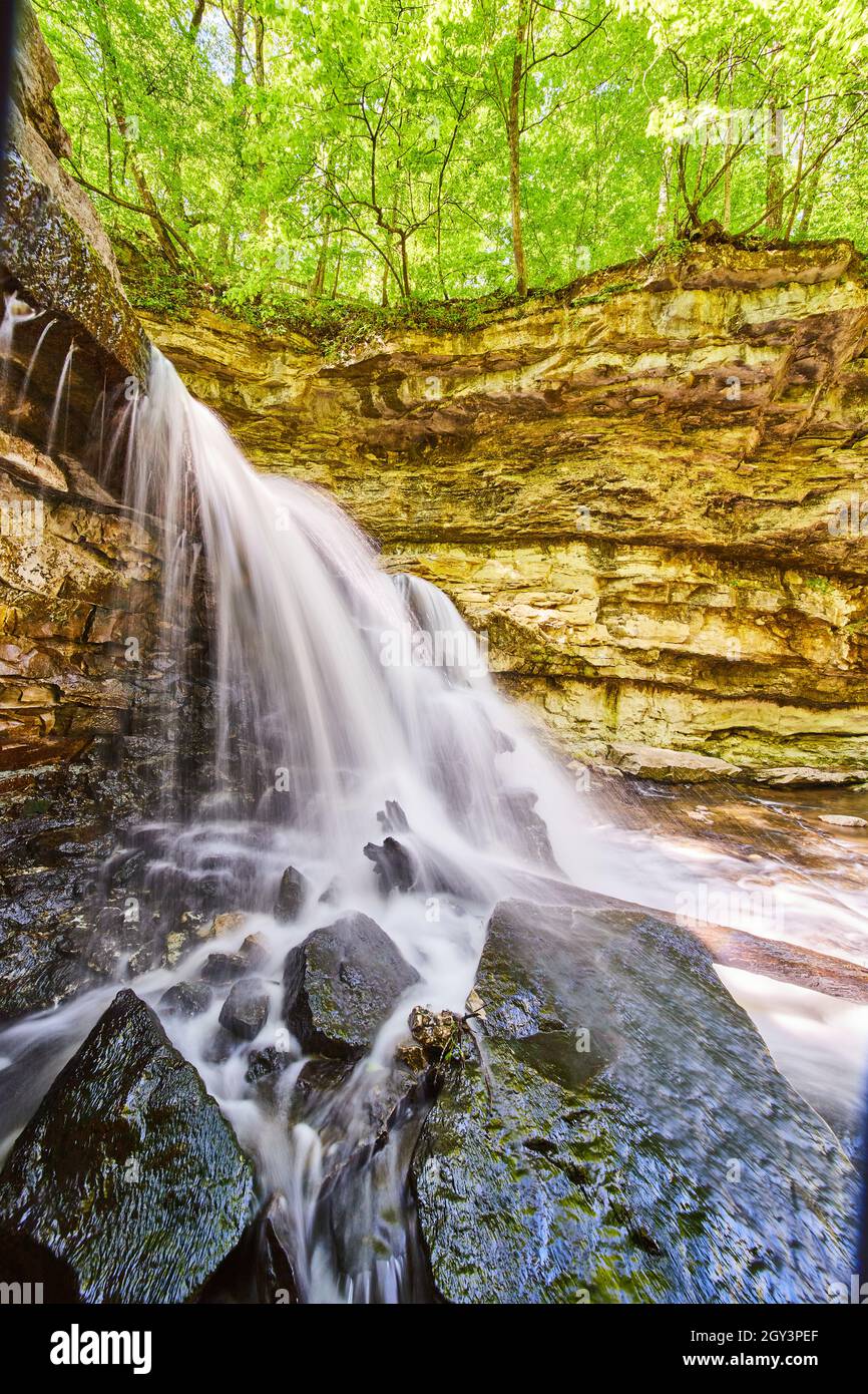 Boulder with waterfall splashing onto it in canyon Stock Photo - Alamy