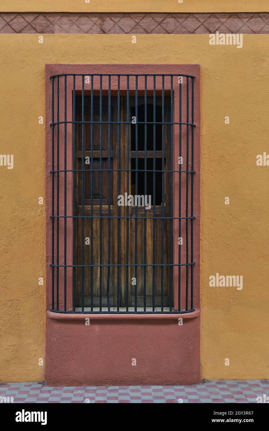 Mustard yellow facade window and antique wood Stock Photo - Alamy