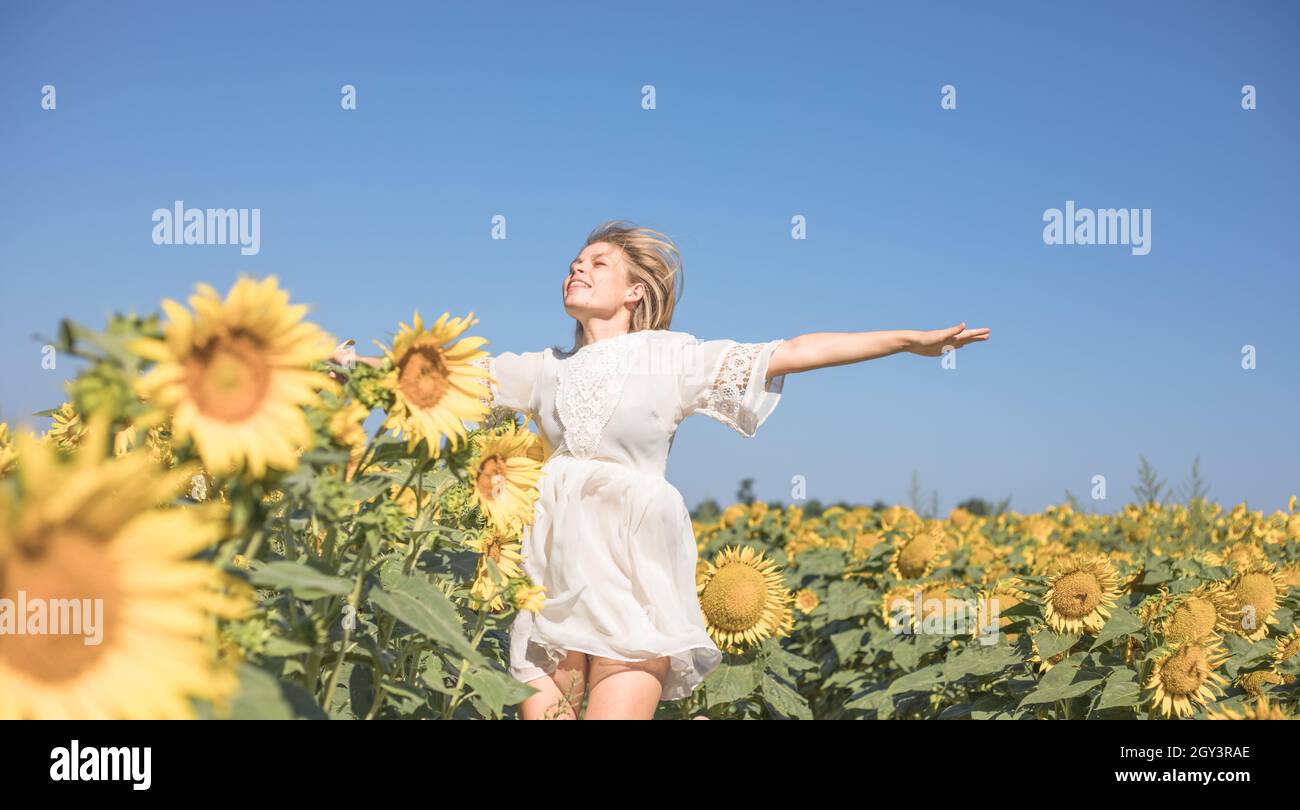 Beauty Sunlit Woman On Yellow Sunflower Field Freedom And Happiness
