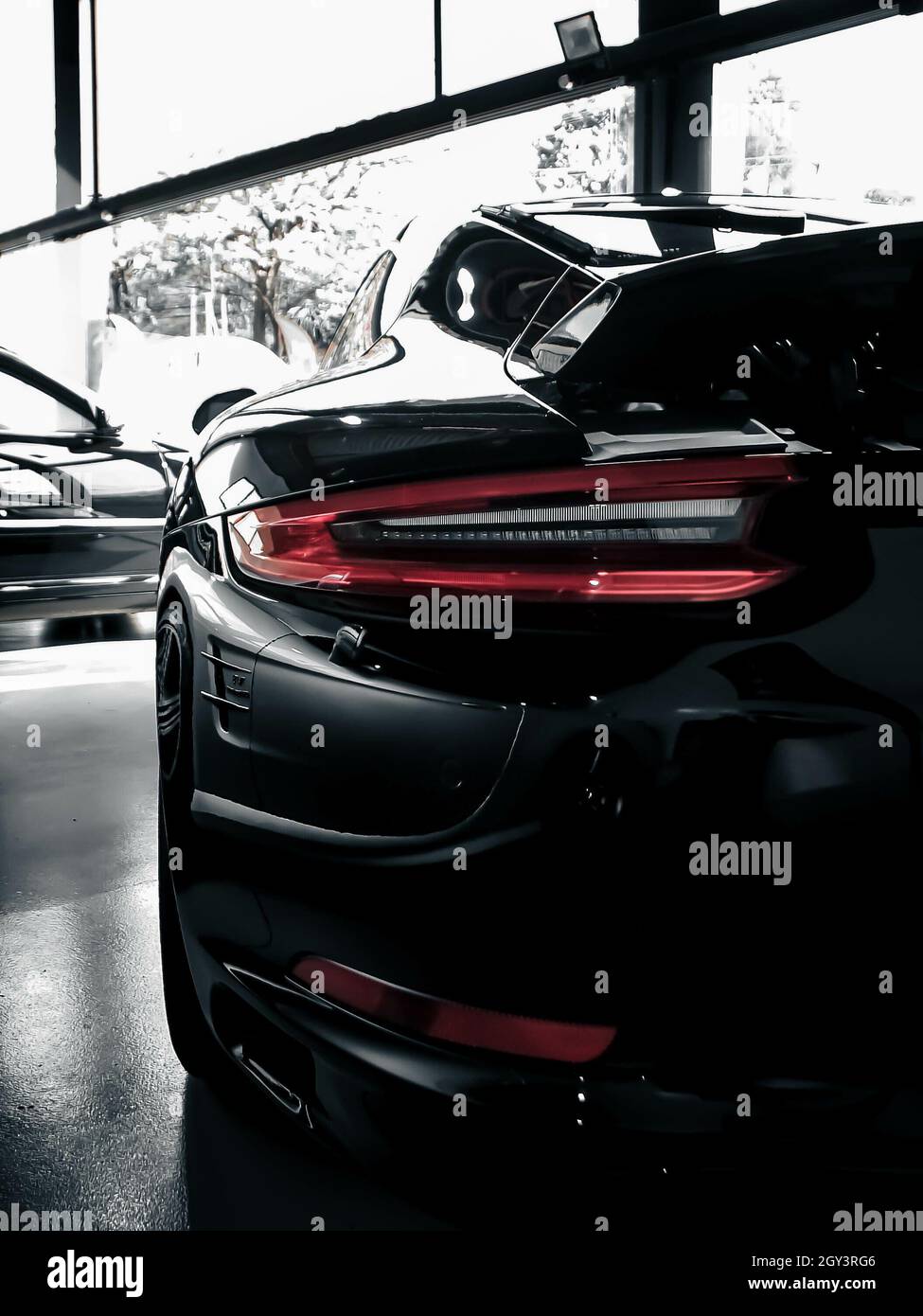 Vertical shot of a black sedan car rear detail in a salon Stock Photo ...