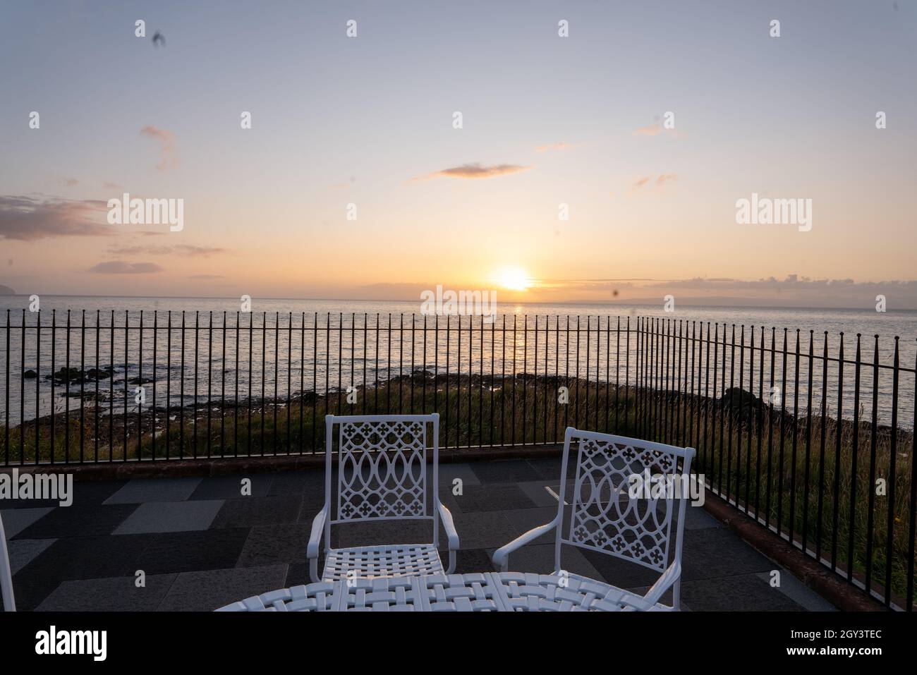 Scenic view at a balcony overlooking a beautiful coast at sunset Stock ...