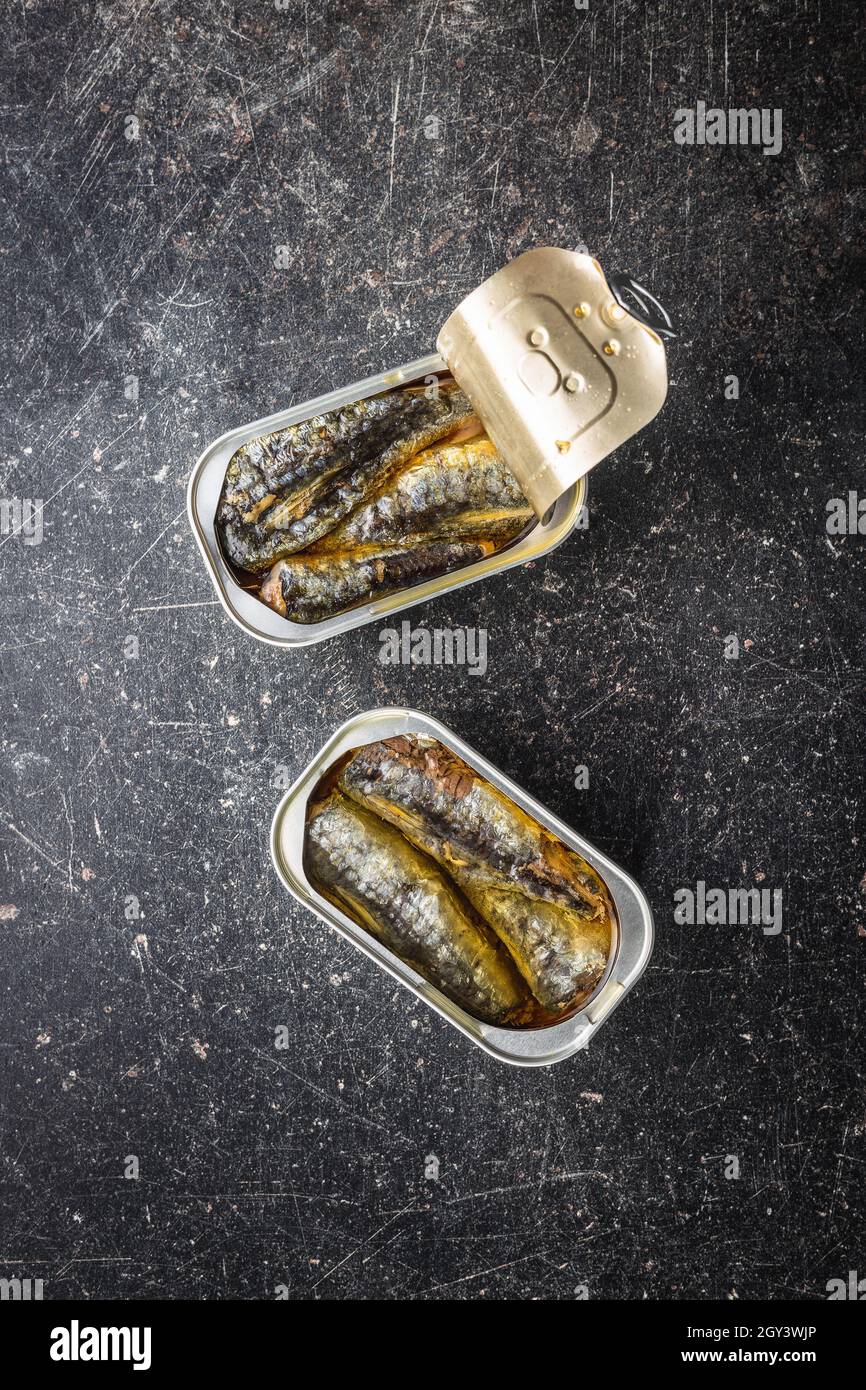 Canned sardines. Sea fish in tin can on black table. Top view Stock ...