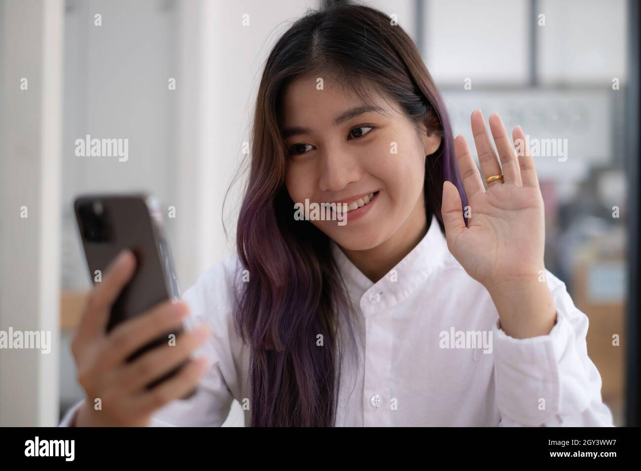 Portrait of Asian beautiful girl making video calling and waving hand ...