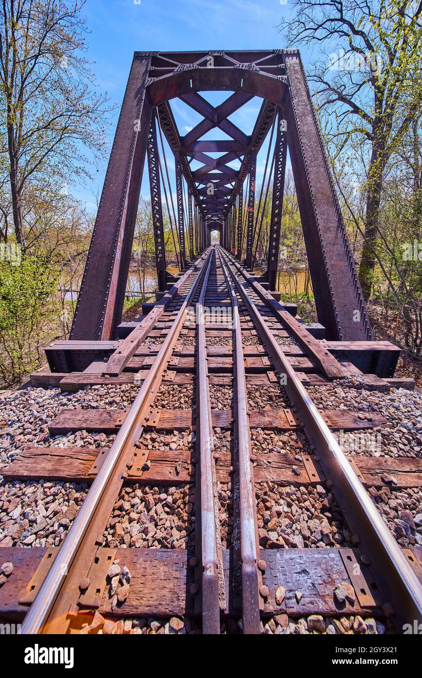 Detail on train tracks with bridge for train over water Stock Photo - Alamy