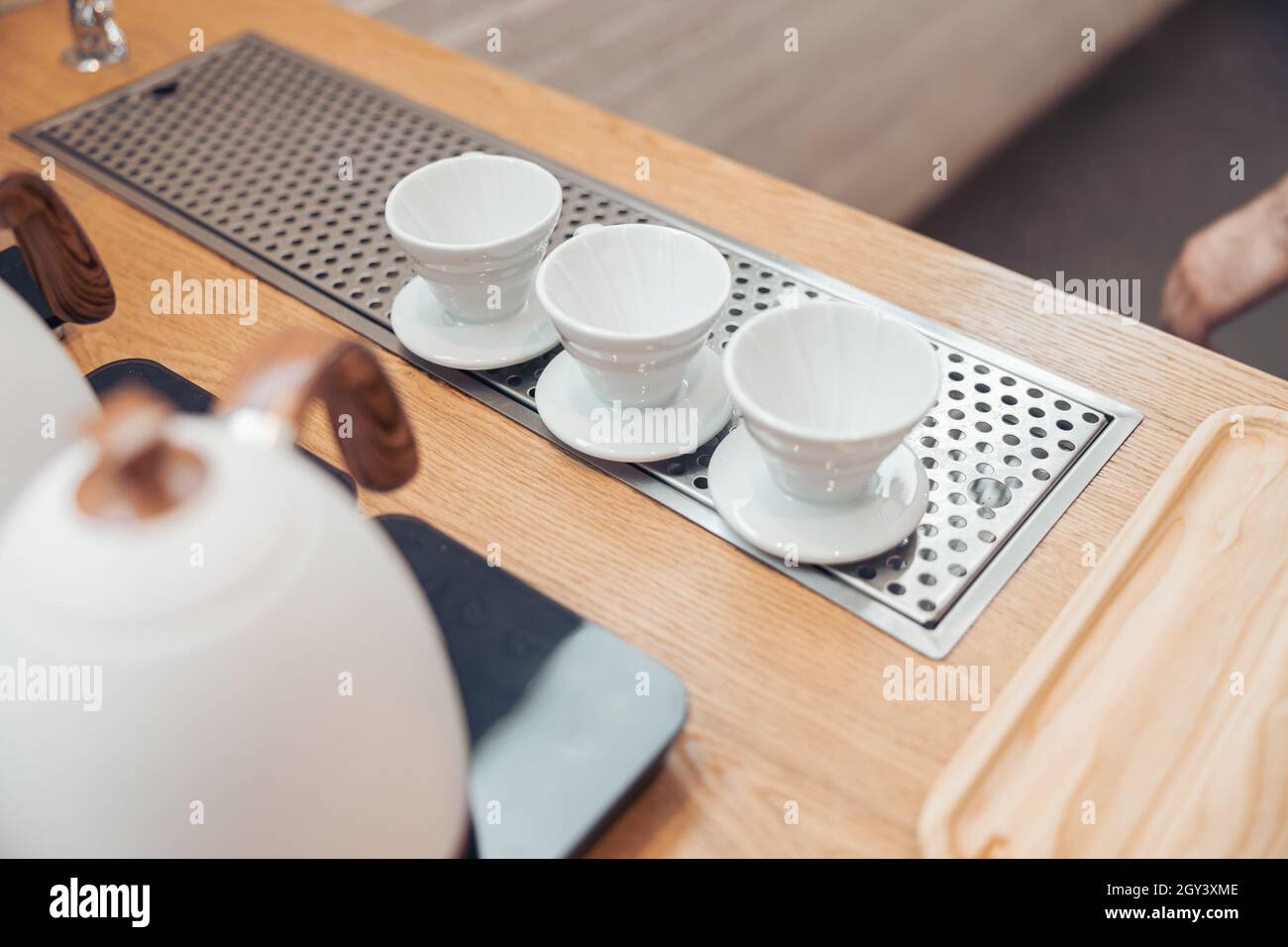 Porcelain coffee cups on counter in cafeteria Stock Photo - Alamy