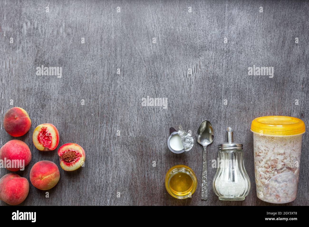 Ingredients for oatmeal on dark wooden table. Concept of healthy food ...