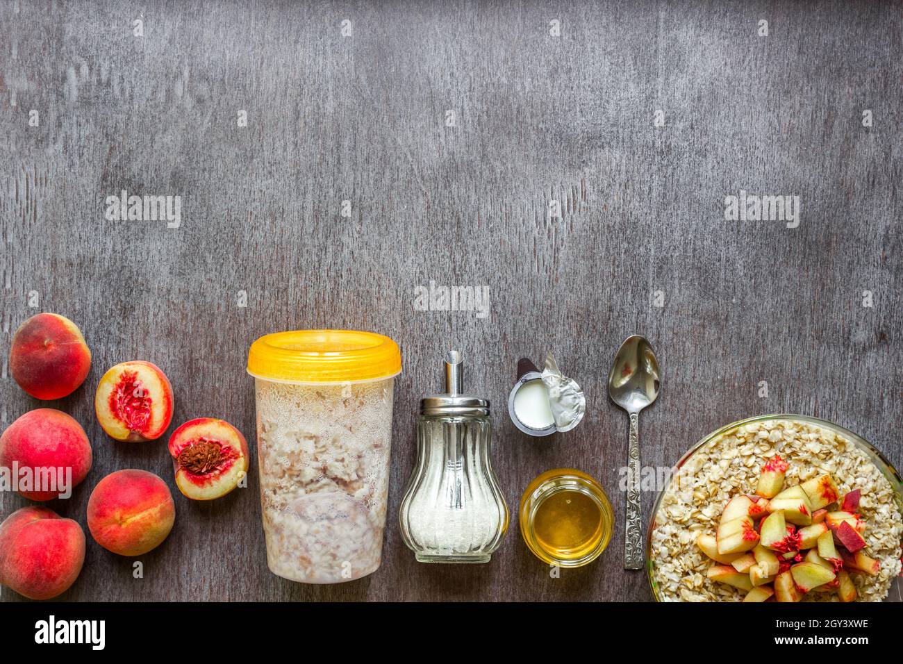 Ingredients for oatmeal on dark wooden table. Concept of healthy food ...