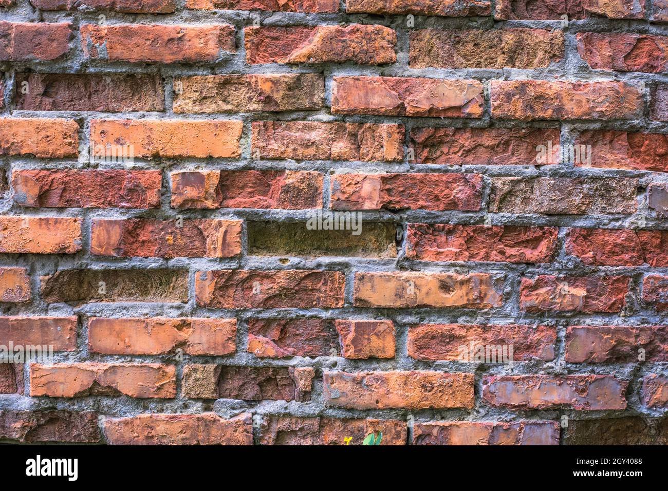 Weathered stained grunge brick wall, abstract background texture with ...