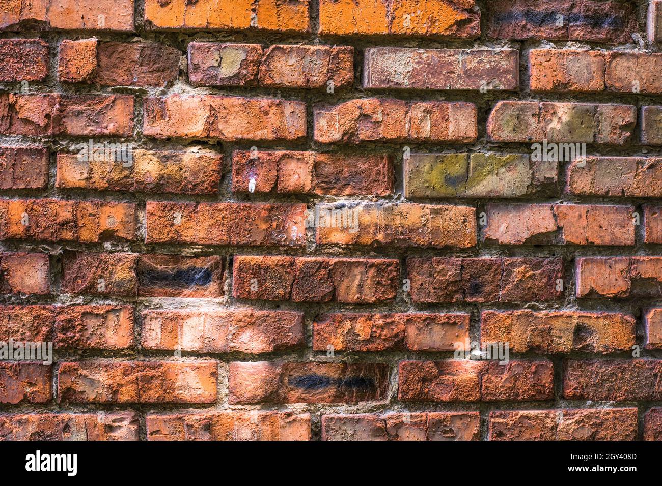 Weathered stained grunge brick wall, abstract background texture with ...