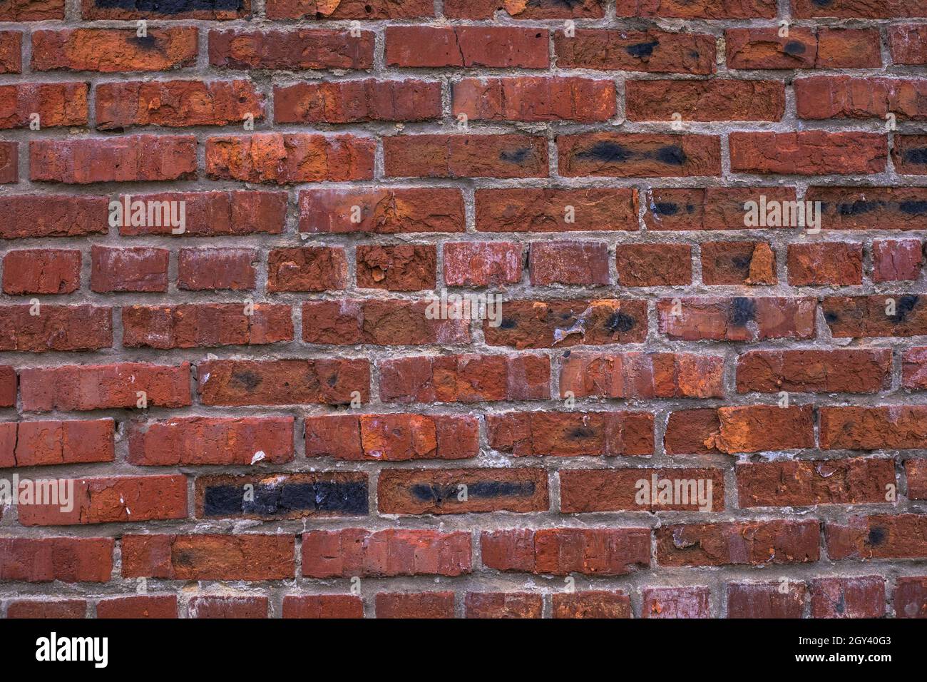 Weathered stained grunge brick wall, abstract background texture with ...