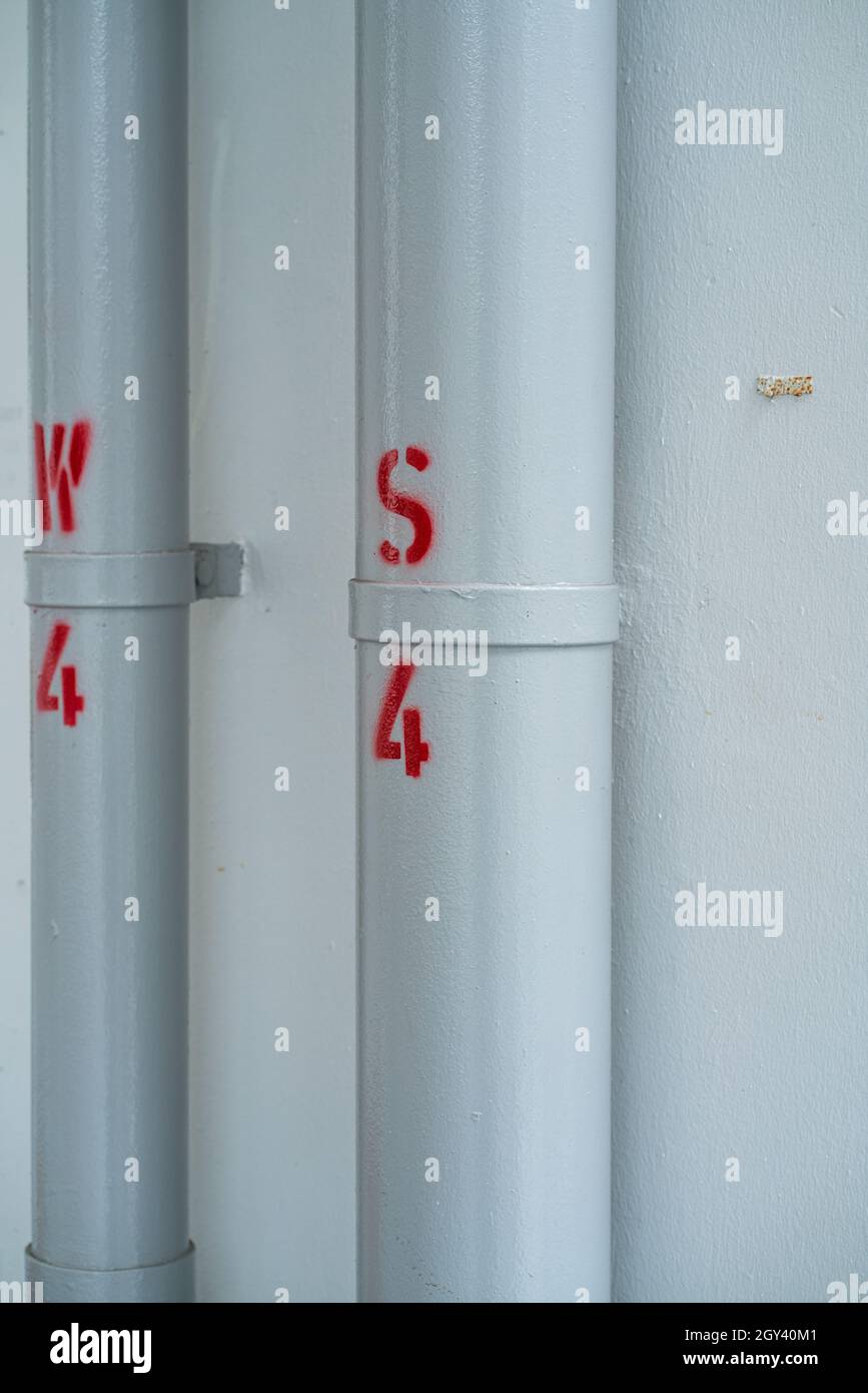White textured wall with white pipes outdoors Stock Photo - Alamy