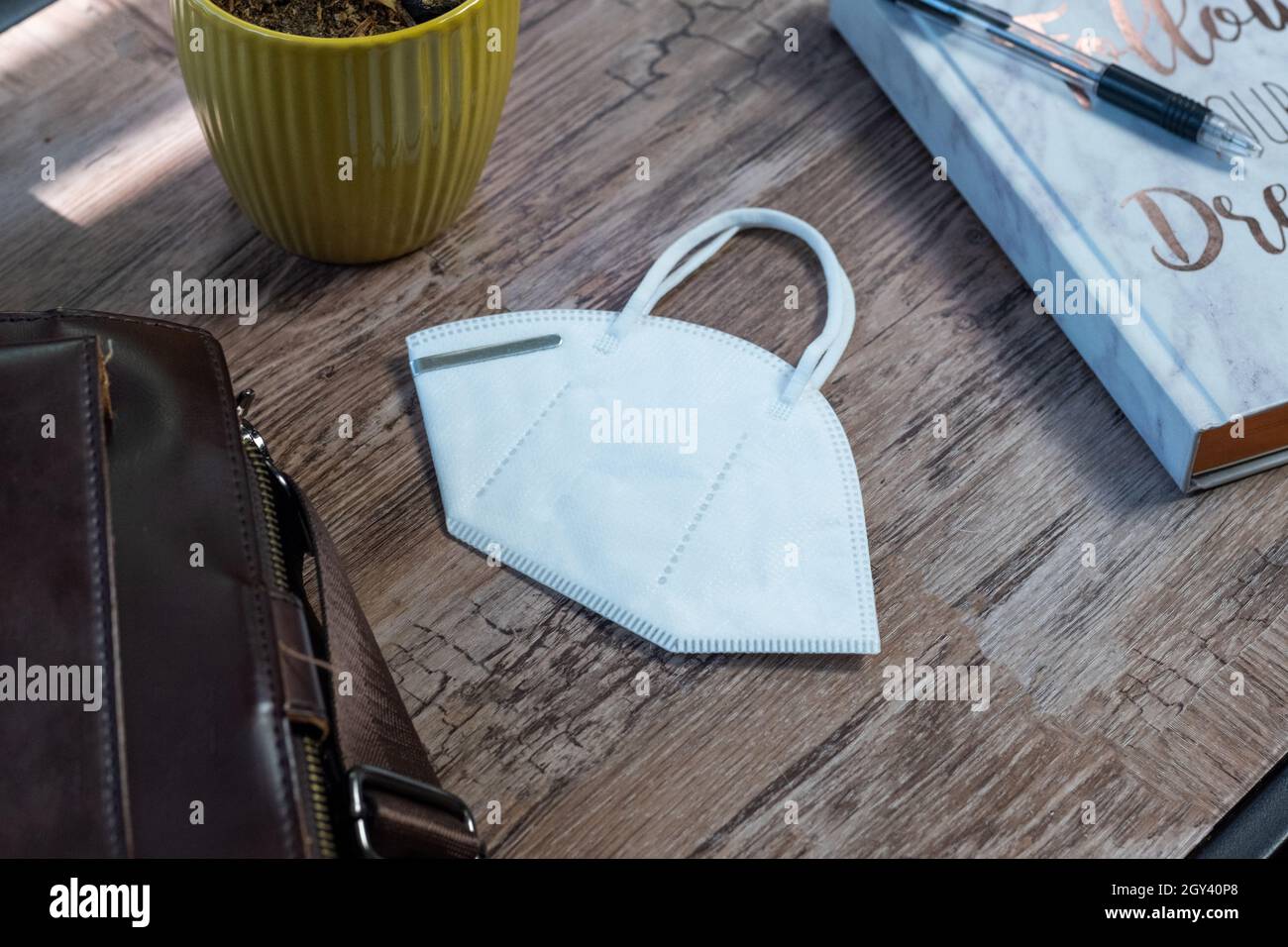 Desktop with face masks on top and office elements Stock Photo - Alamy