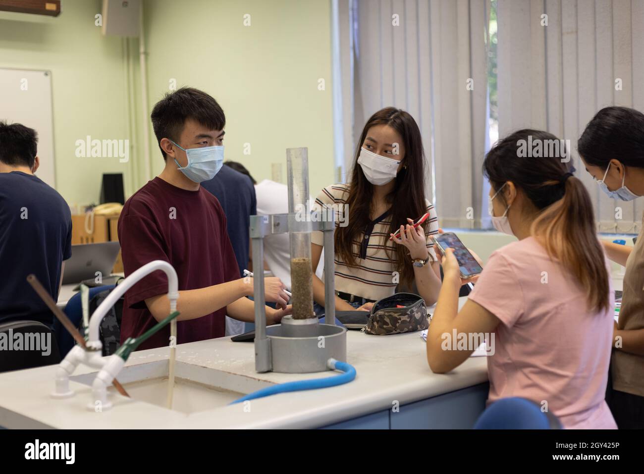10 4 2021 Group of young students do hydraulic test of soil samples ...
