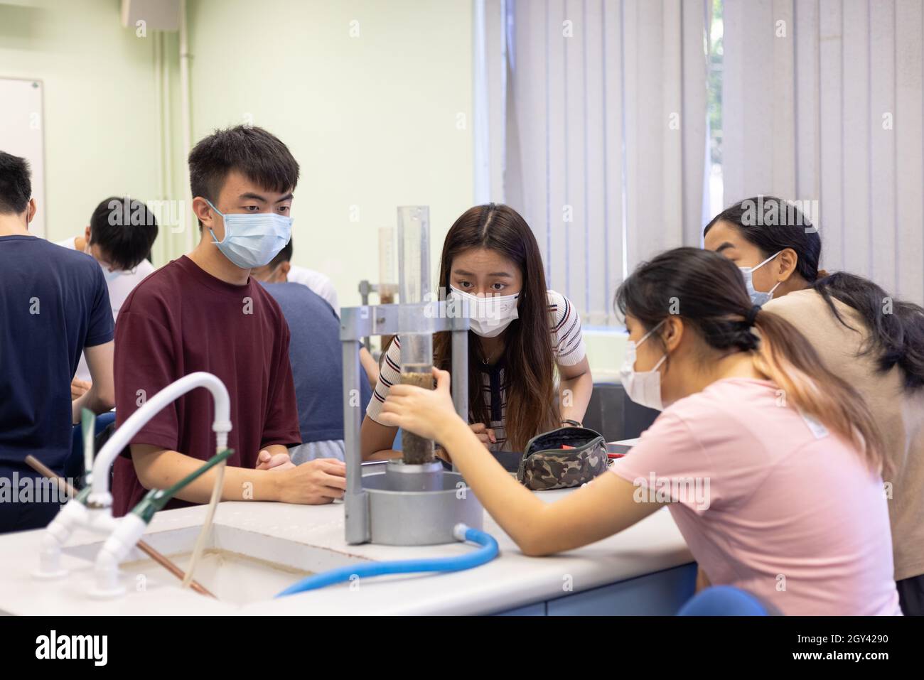 10 4 2021 Group of young students do hydraulic test of soil samples ...