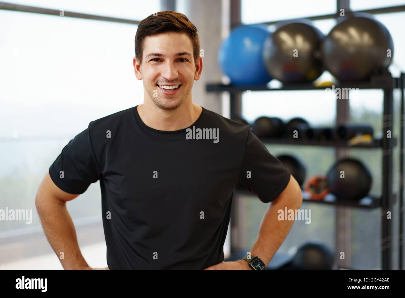 Smiling handsome trainer arms hi-res stock photography and images - Alamy