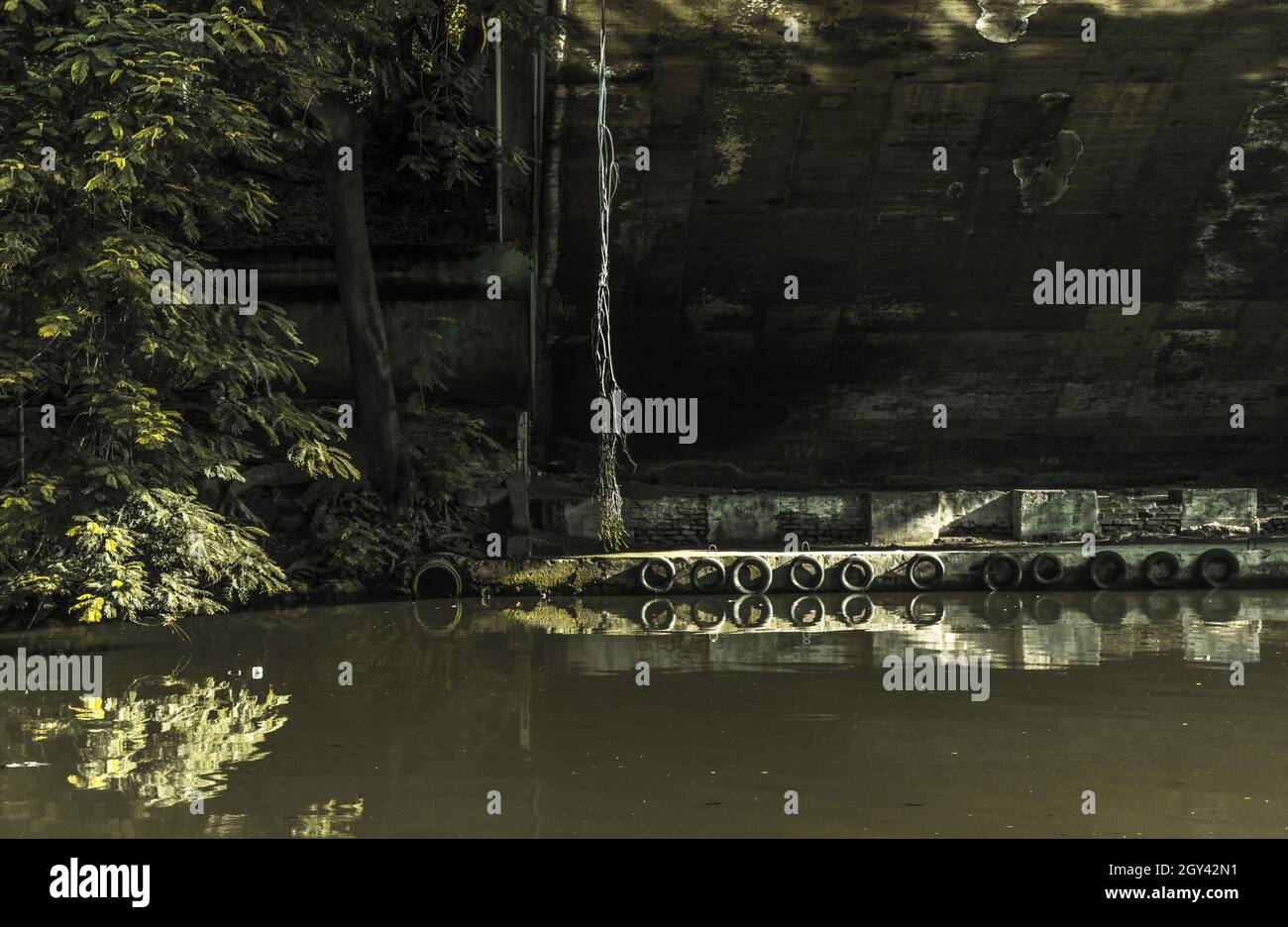 Deep river near the old concrete wall Stock Photo - Alamy