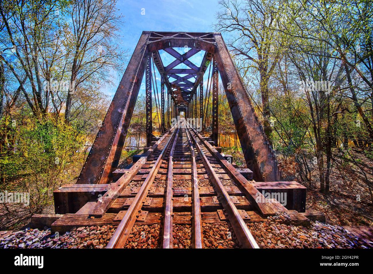 Colorful steel bridge for train tracks over river Stock Photo - Alamy