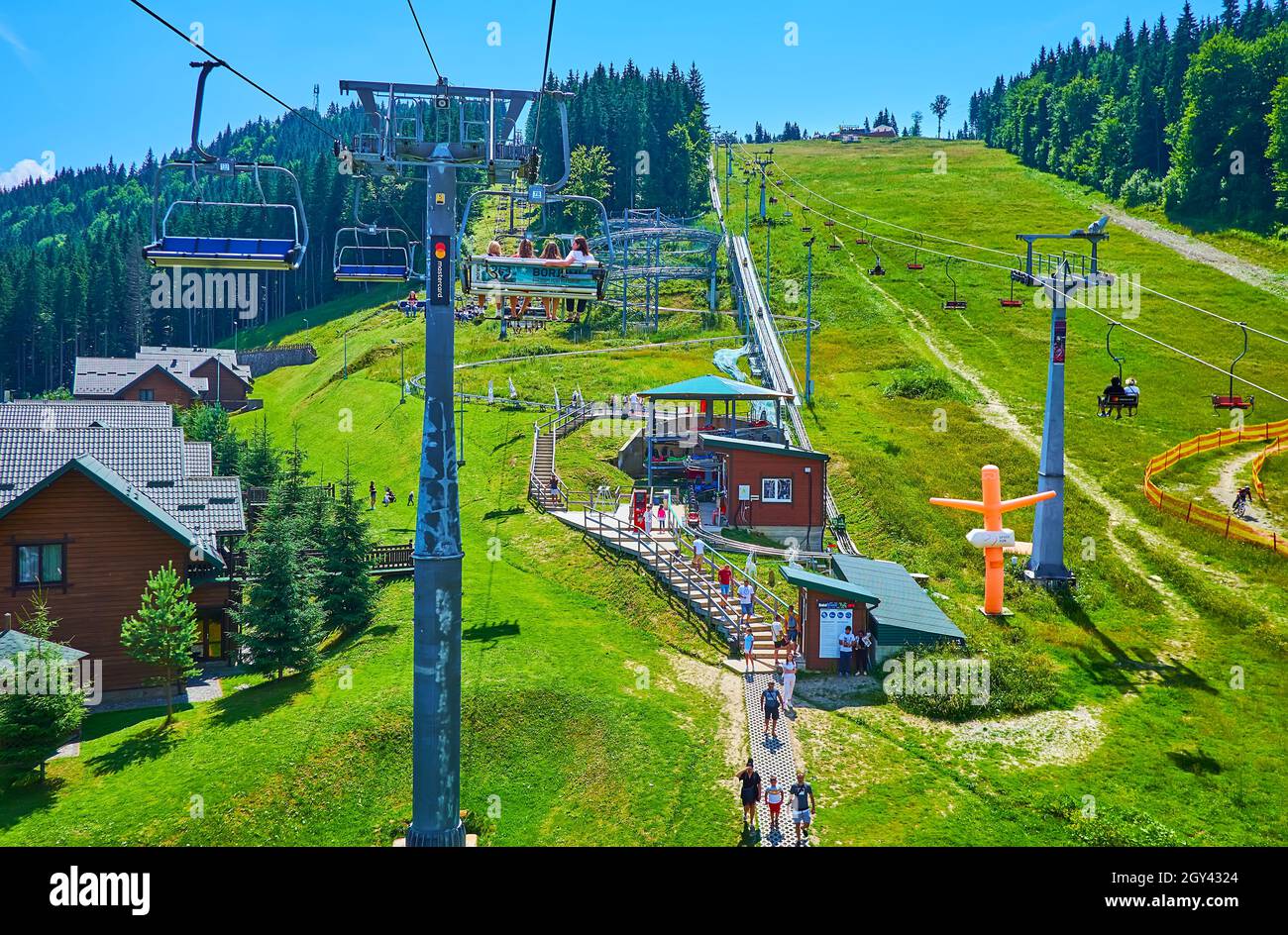 BUKOVEL, UKRAINE - JULY 25, 2021: The green slope of Mount Bukovel with ...