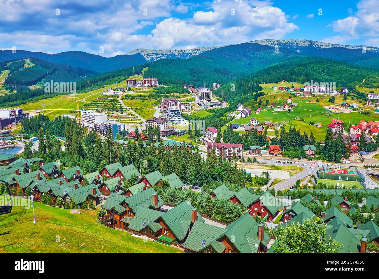 The cable car observes the modern roofs, cottages and hotels of Bukovel ...