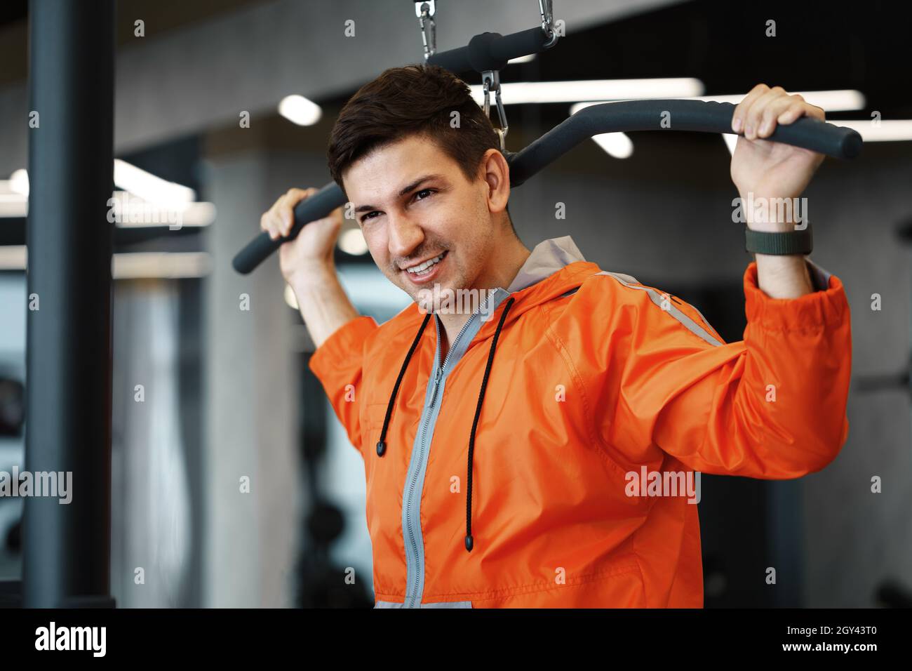 Young man working out training back muscles in the gym Stock Photo - Alamy