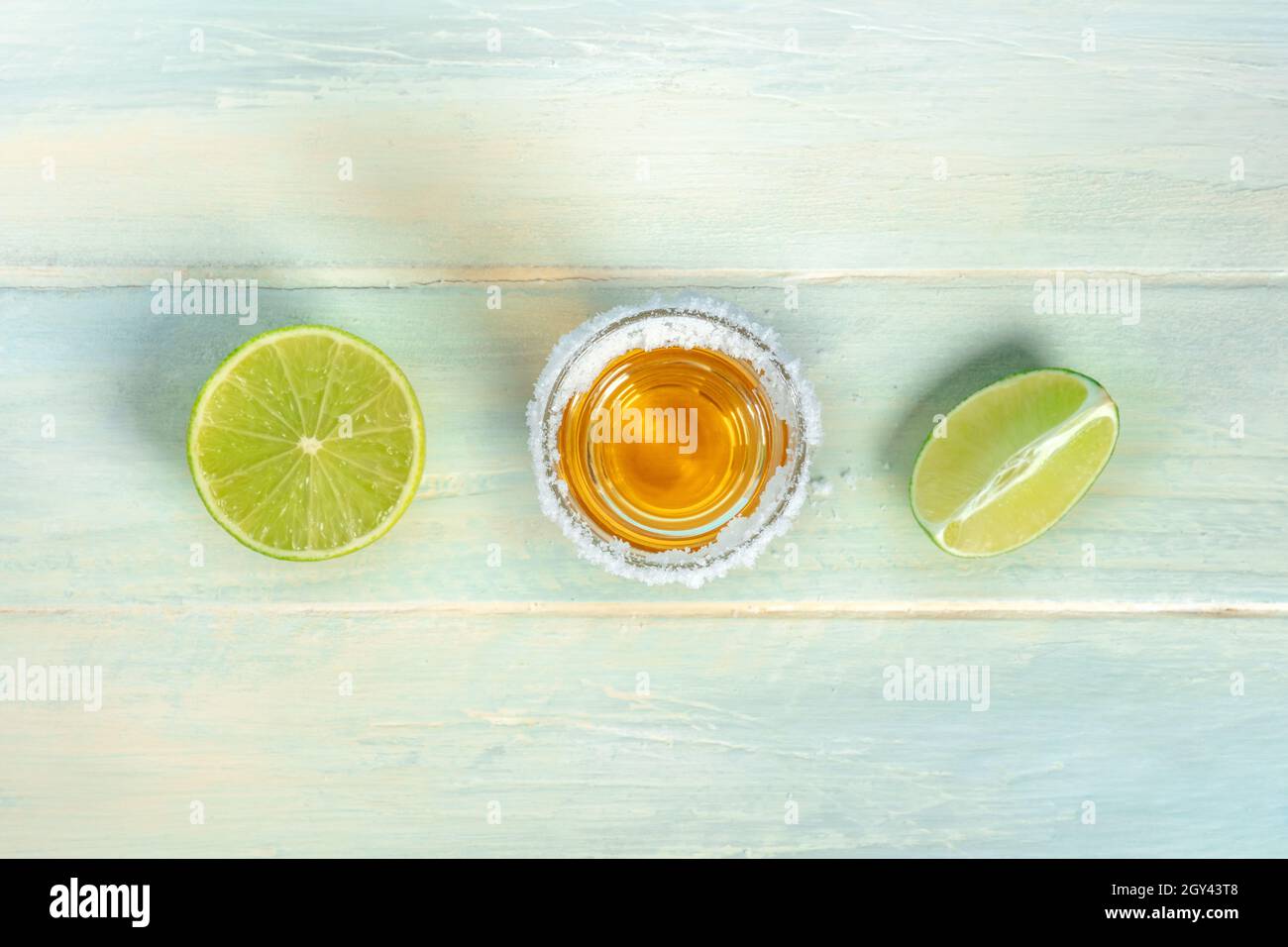 Tequila shot with lime slices, a Mexican drink with a salt rim ...