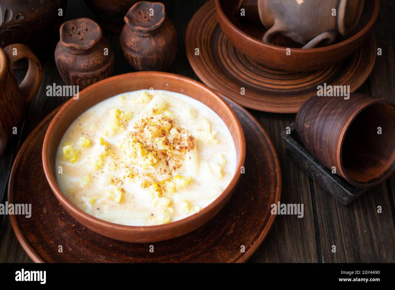 A serving of clam chowder in an old rustic bowl, traditional milk soup ...