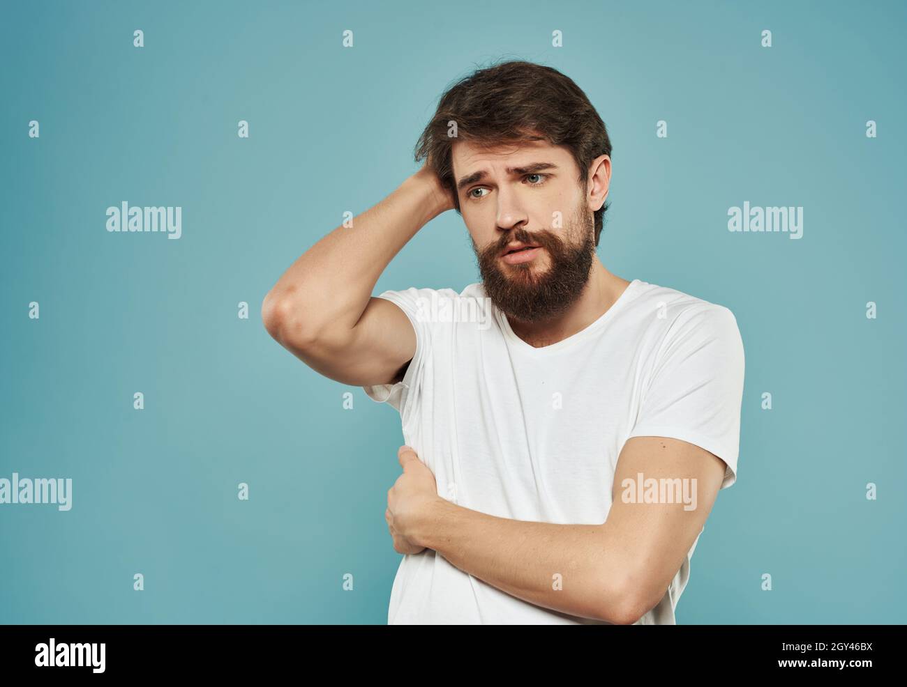 Man in a white t-shirt irritated facial expression Studio Stock Photo ...