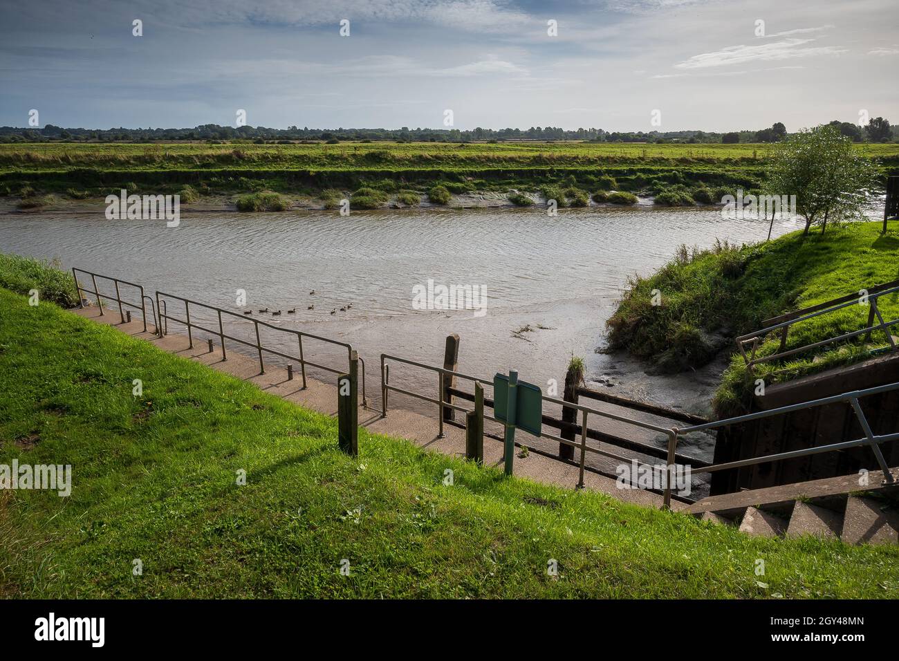 The entrance to Salters Lode lock at low tide from the Great River Ouse ...