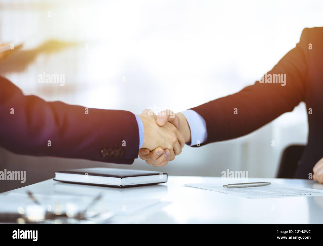 Business people shaking hands at meeting or negotiation, close-up ...