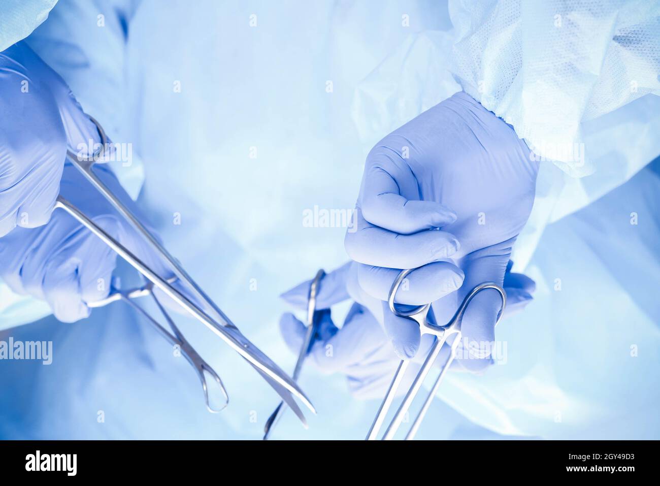A group of surgeons is operating at the hospital, close-up of hands ...