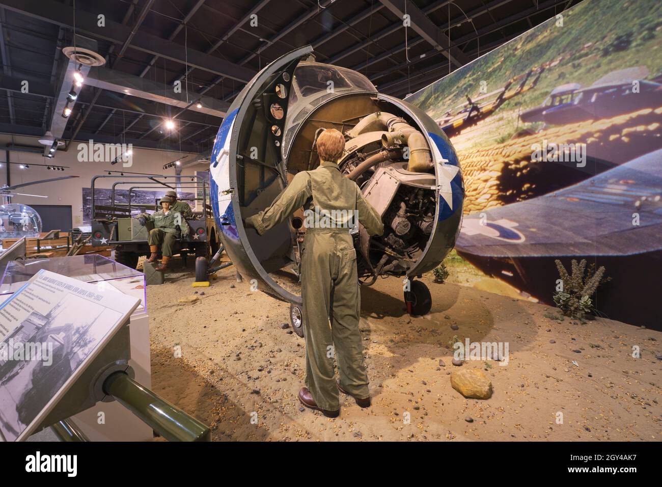 A diorama of a soldier mechanic repairing an H-19 helicopter during the ...