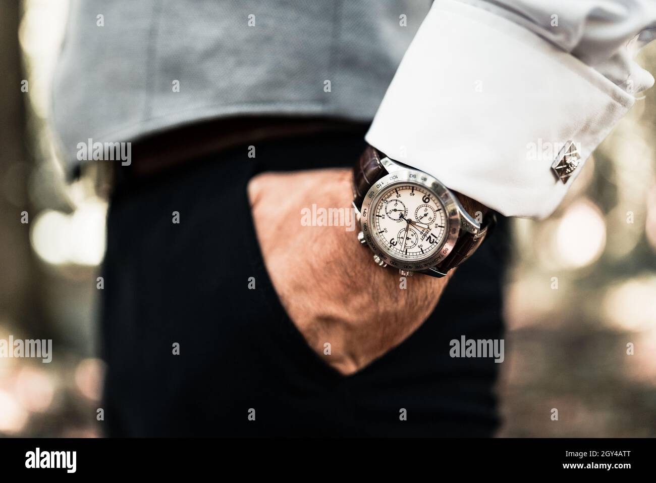Stylish young men with clocks Stock Photo - Alamy