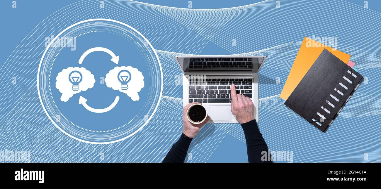 Top view of hands using laptop with symbol of knowledge sharing concept ...