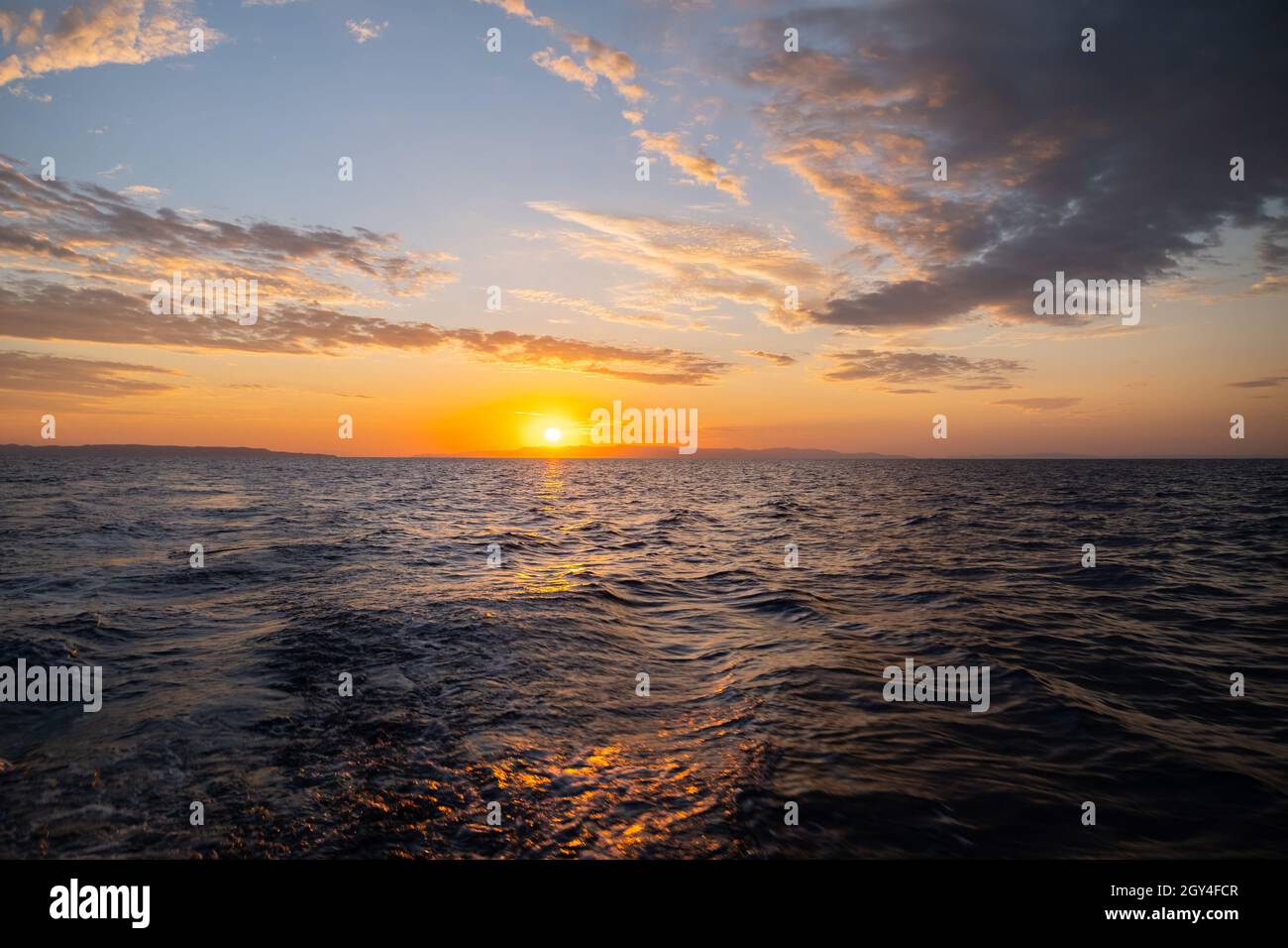 Golden sun rises over ocean hi-res stock photography and images - Alamy