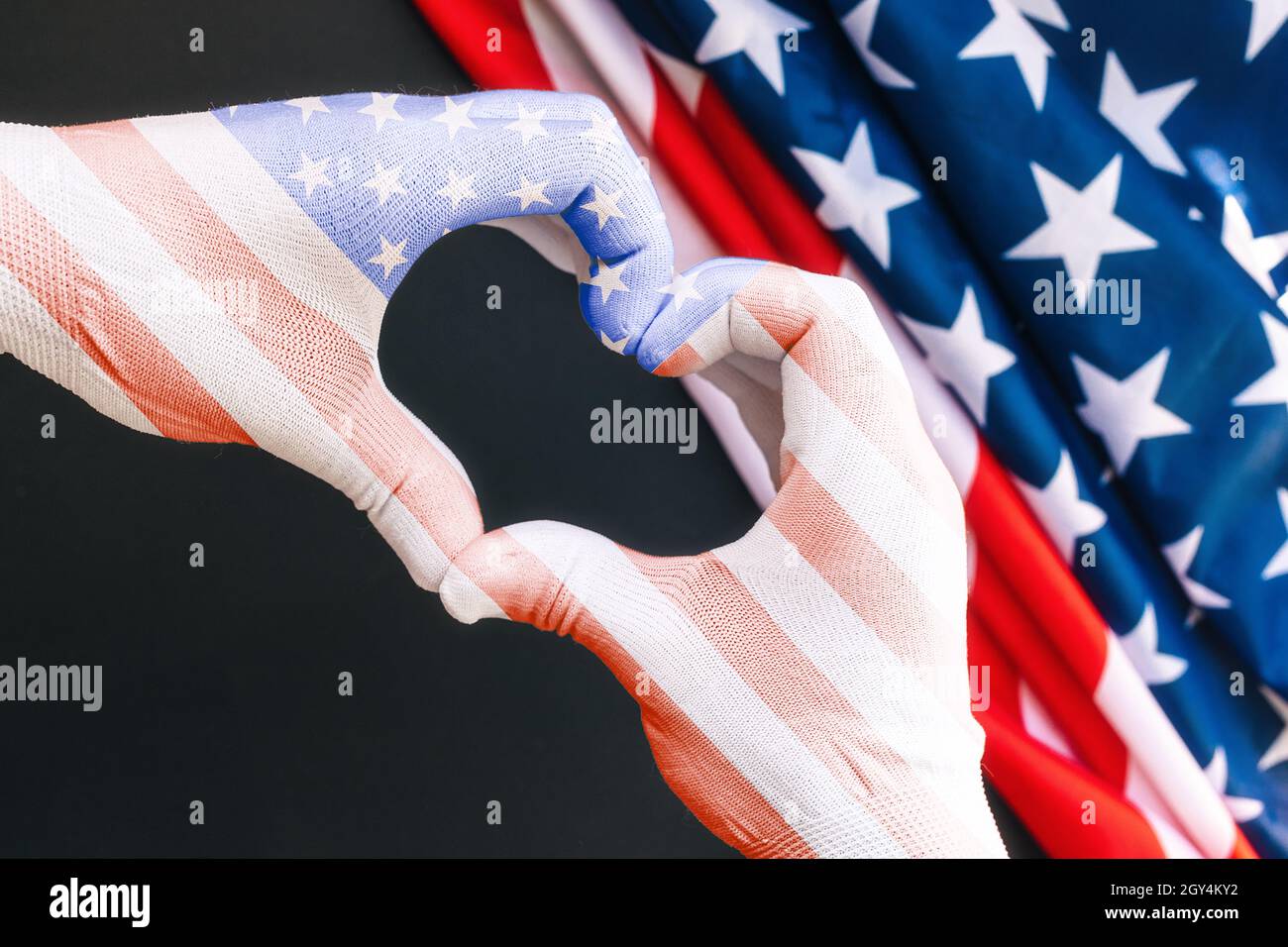 Patriotism. Man's hands in gloves the color of the American flag ...