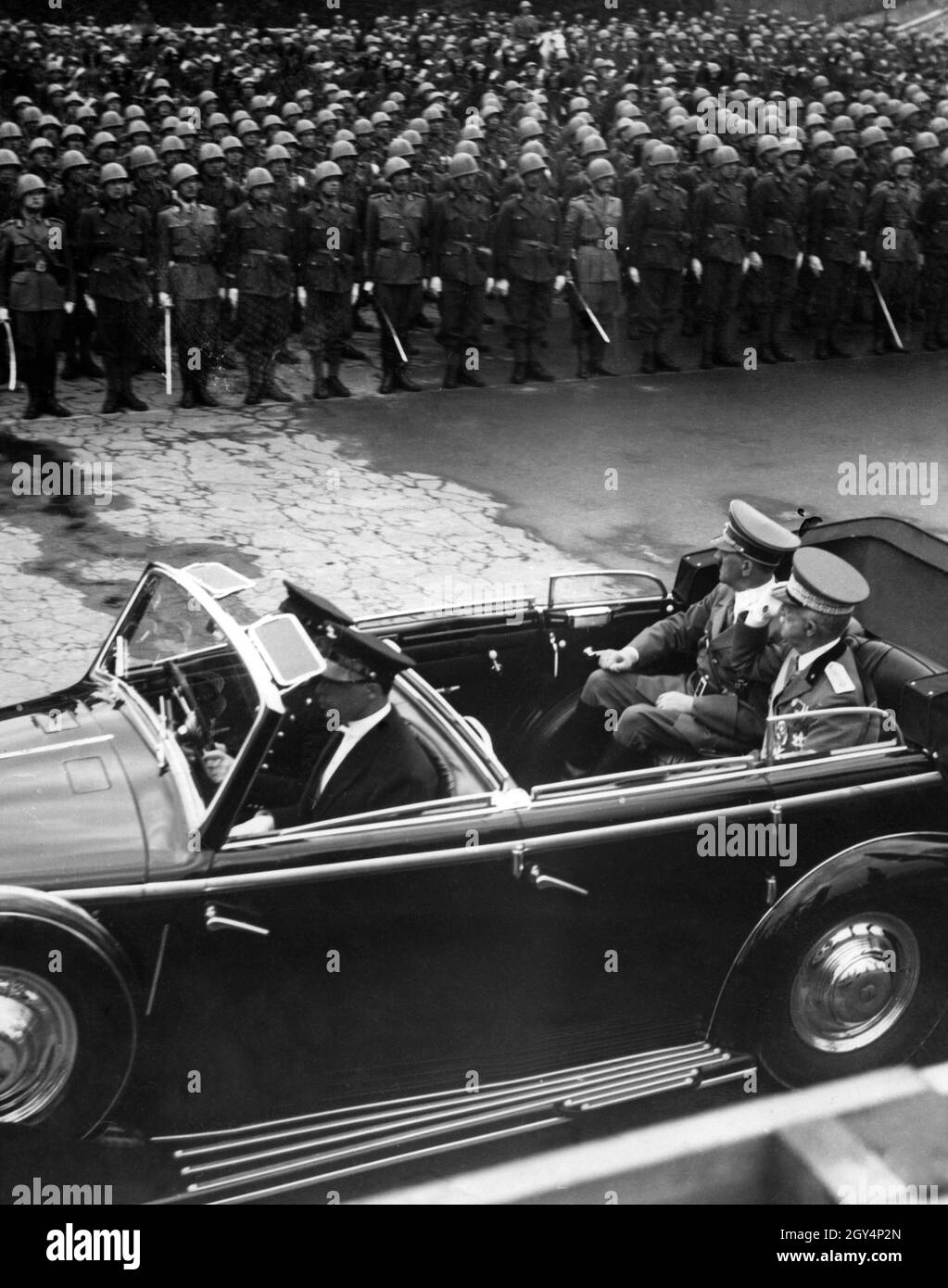 Adolf Hitler and the Italian King Viktor Emanuel drive off a military ...