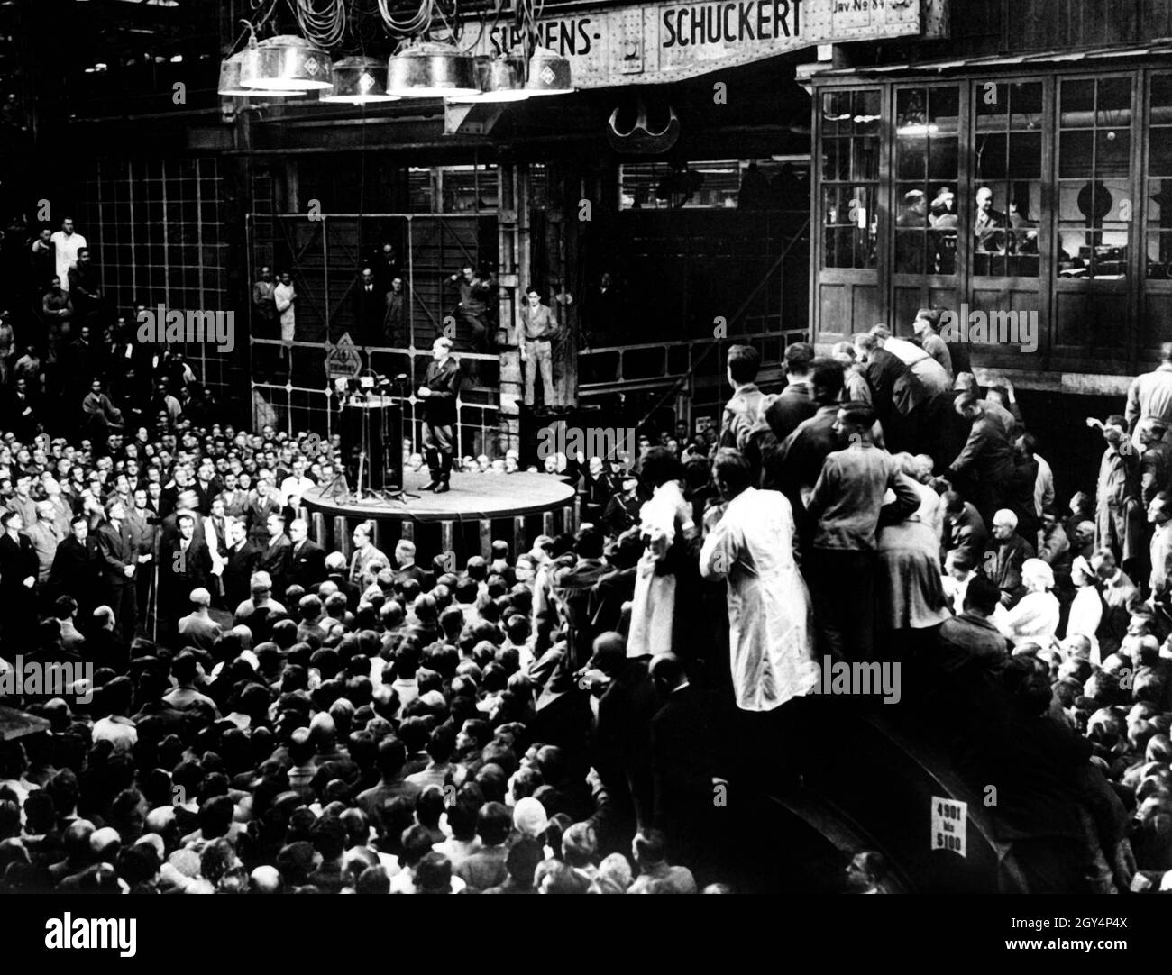 Adolf Hitler speaks to workers in the dynamo hall at the Siemens ...