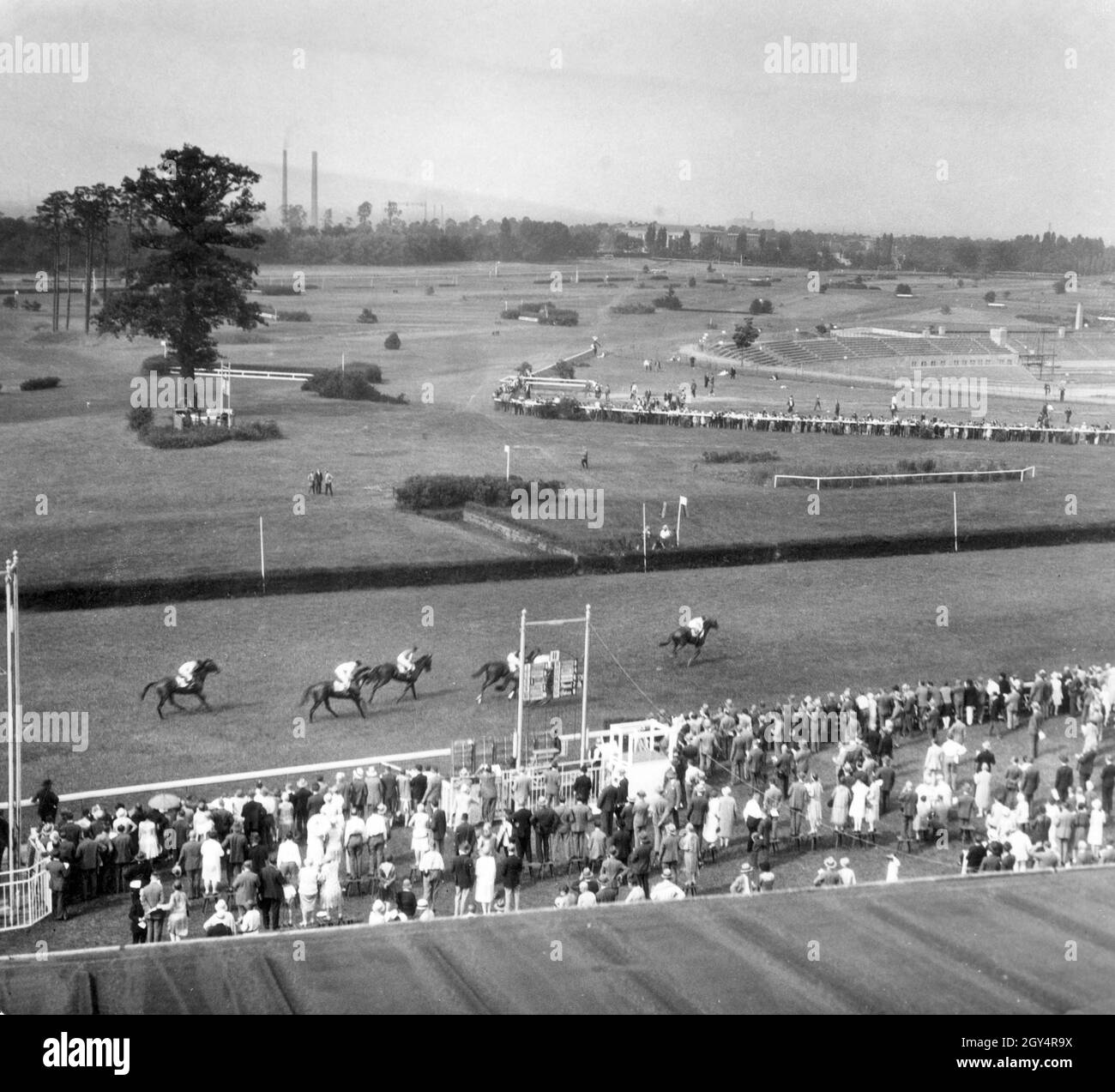 Audience watching a horse race at the Grunewald racecourse near Berlin ...