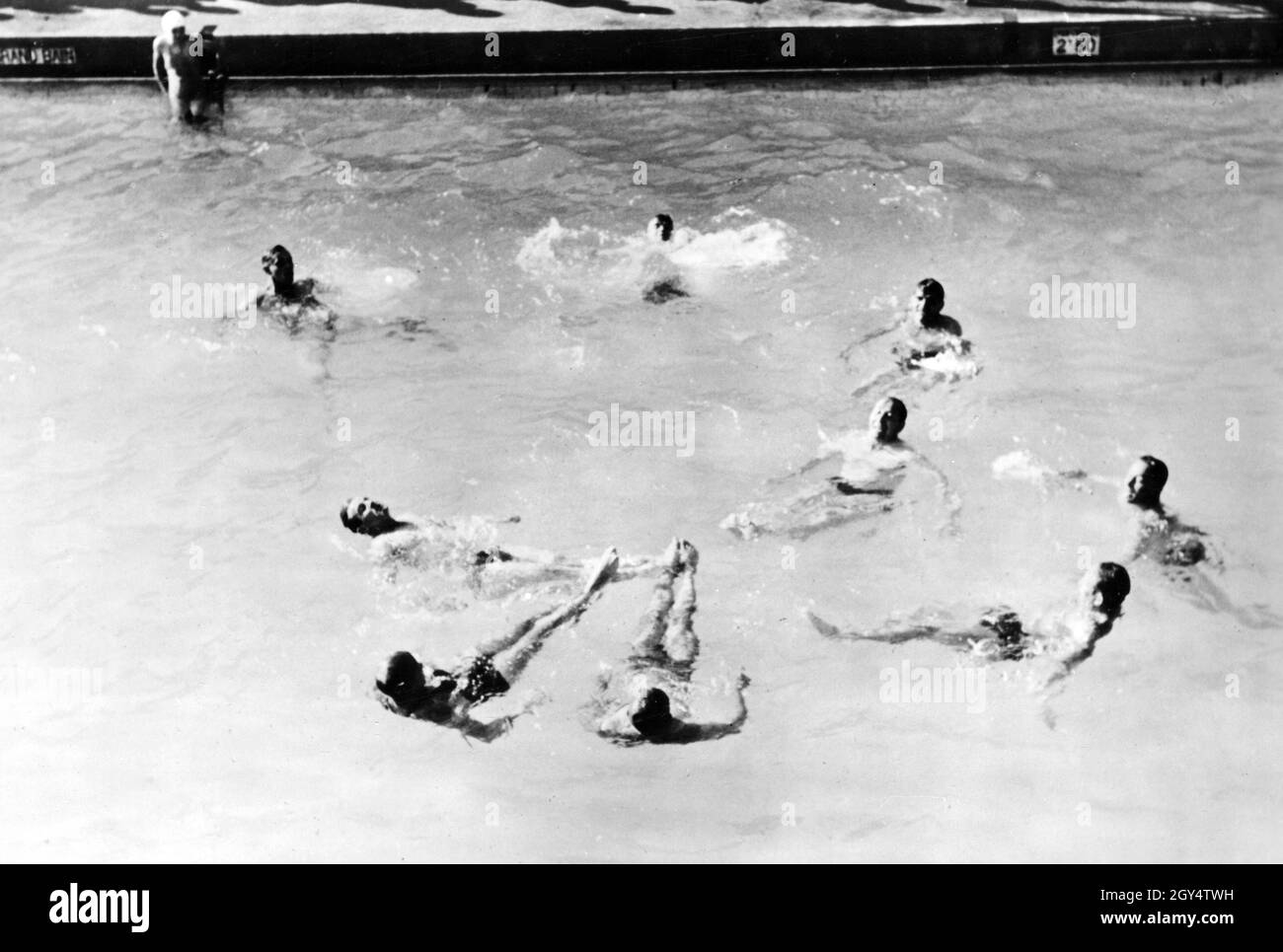 Soldiers of the German Wehrmacht swim in a swimming pool in occupied ...