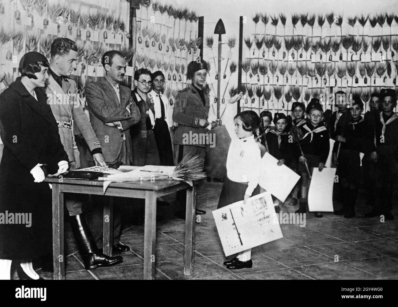 A girl salutes her group leaders from the Opera Nazionale Balilla (ONB ...