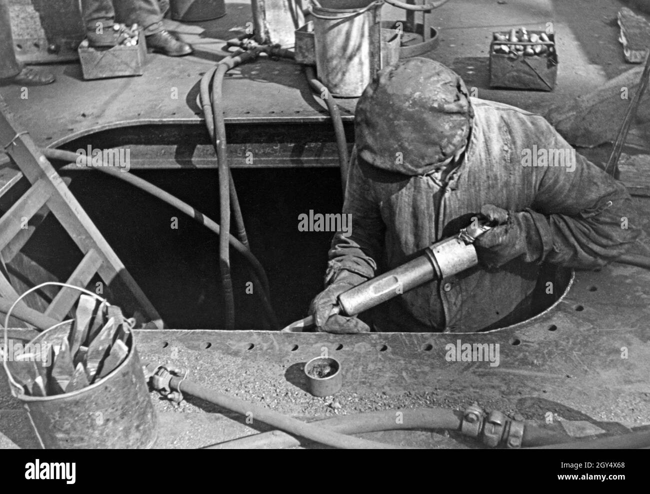 Metal workers riveting inside a ship. [automated translation] Stock ...
