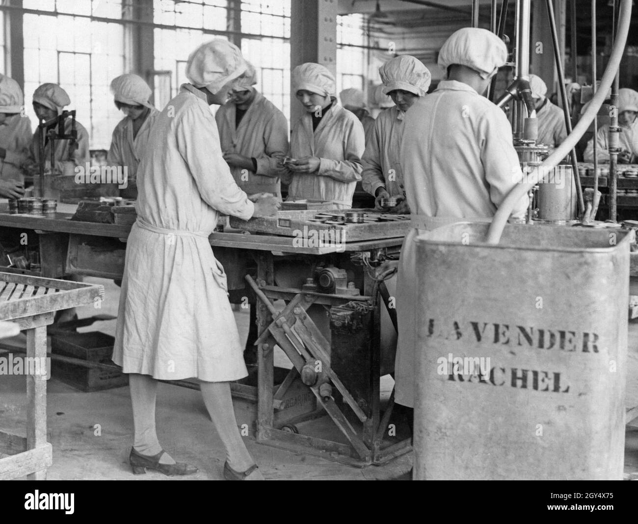 Workers at a powder factory in the UK packing powder. [automated ...