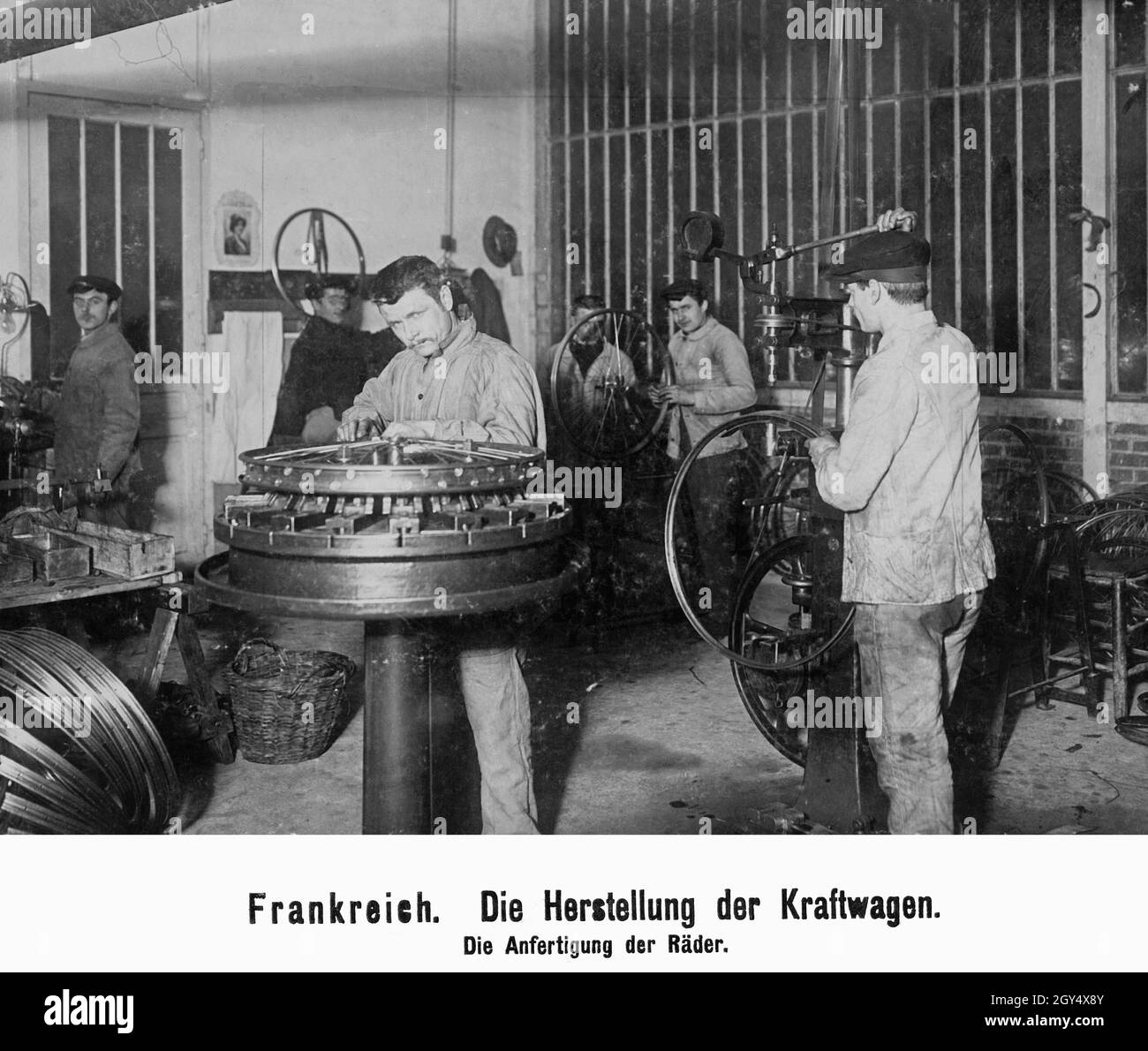 Industrial workers in a French automobile factory making wheels ...