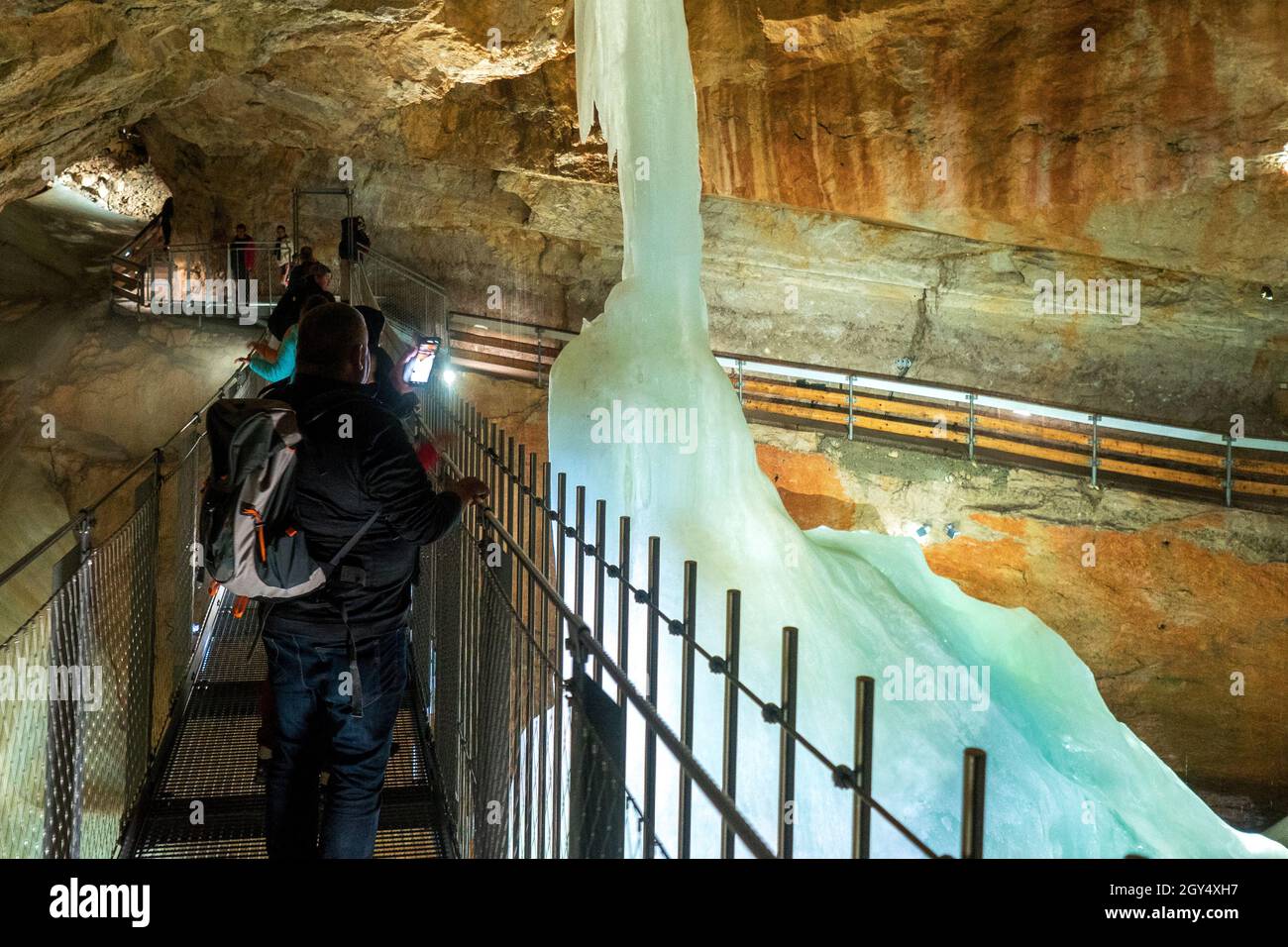 Tourists crossing a rope bridge at the Tristandom inside the Dachstein ...