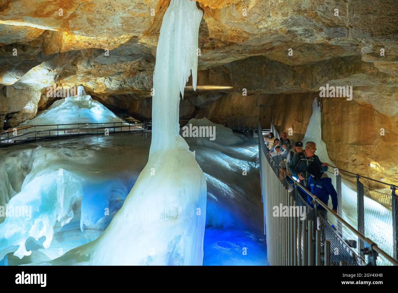 Tourists crossing a rope bridge at the Tristandom inside the Dachstein ...